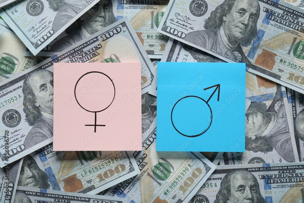 Gender pay gap. Paper notes with male and female symbols on dollar ...