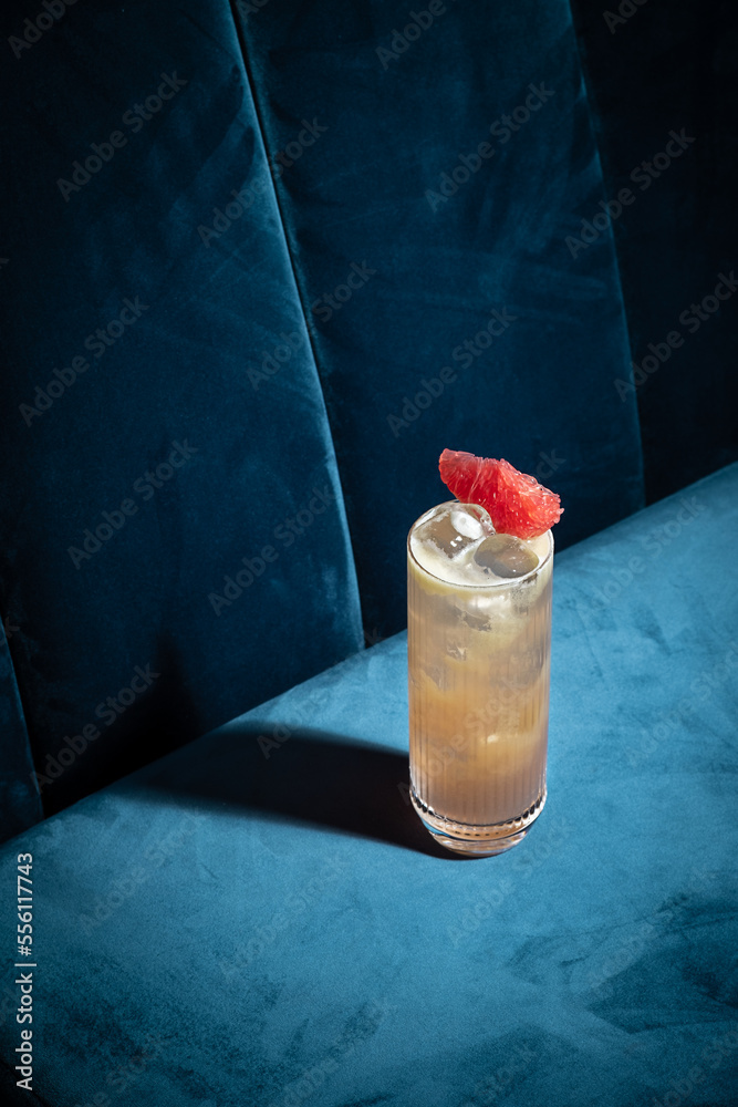 Cocktail on blue background. Modern, stylish drink placed on velvet ...
