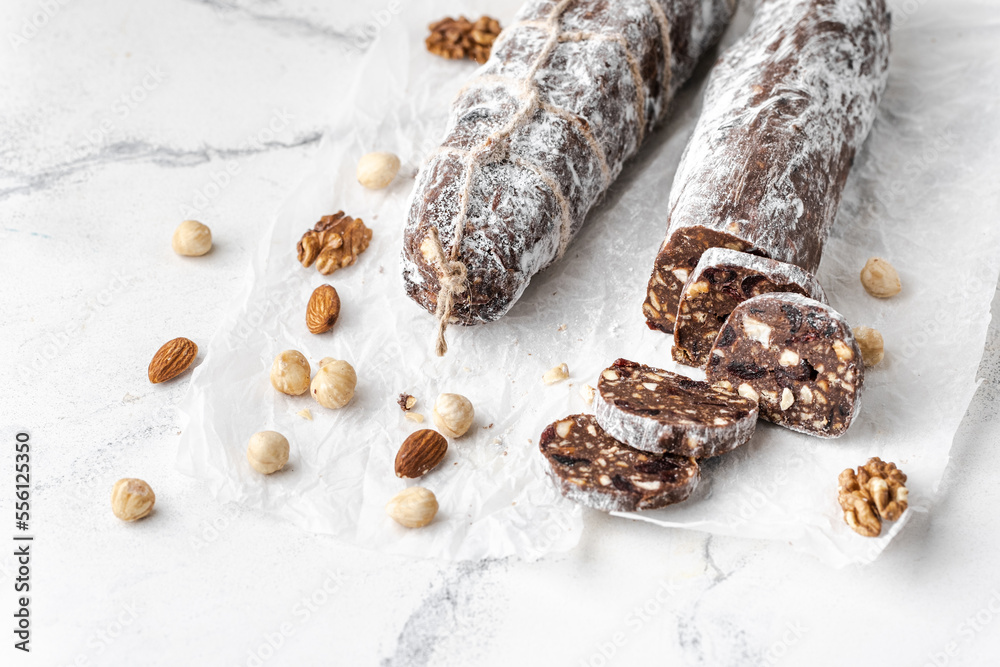Chocolate salami filled with almonds, hazelnuts and raisins on the ...