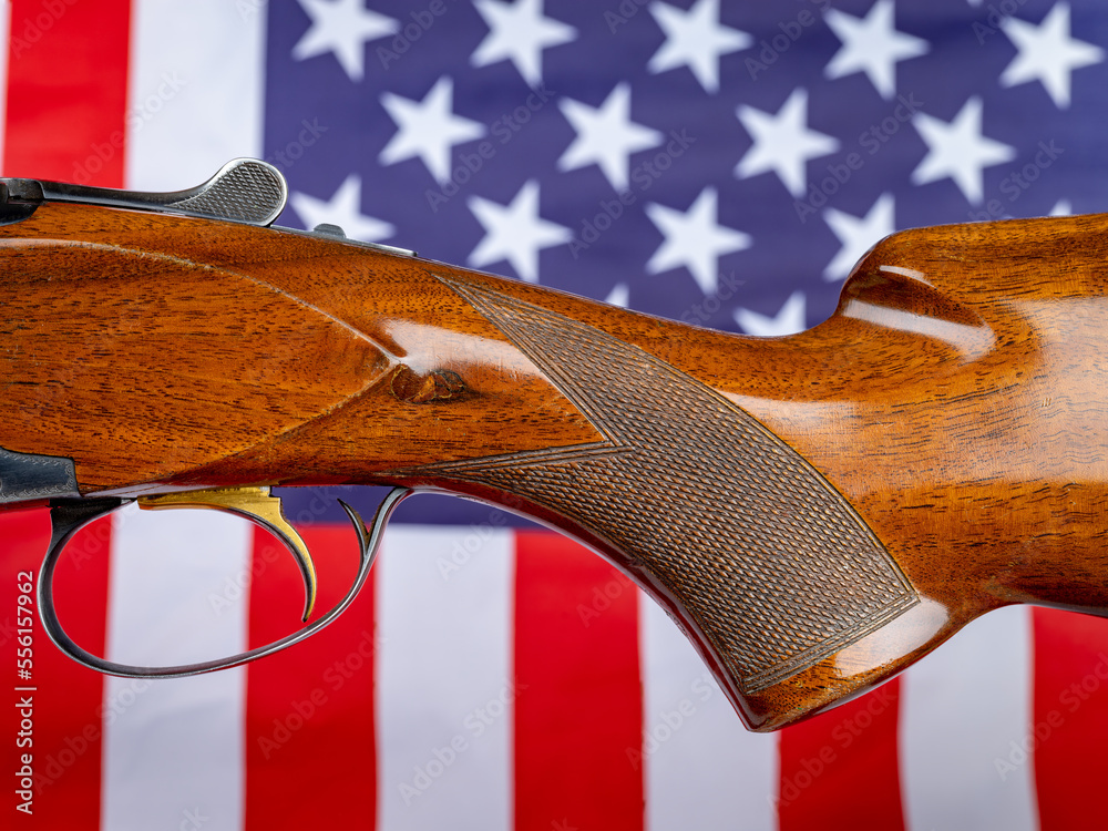Trigger guard of a shotgun with an American flag backdrop Stock Photo ...
