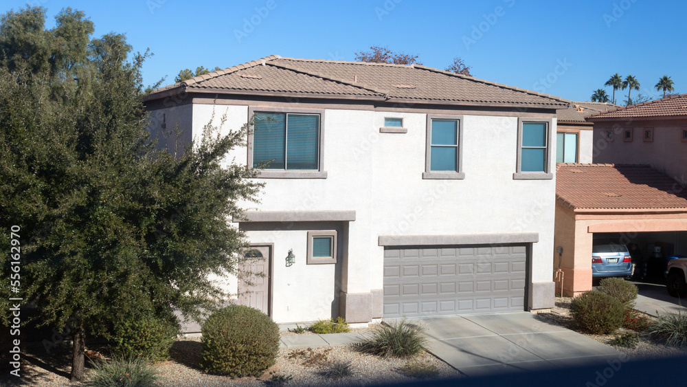 Typical residential single family stucco house in two levels with two ...