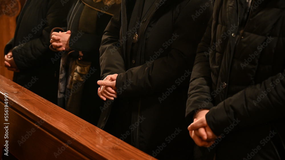 Catholic nun praying with hands folded and fingers crossed during ...