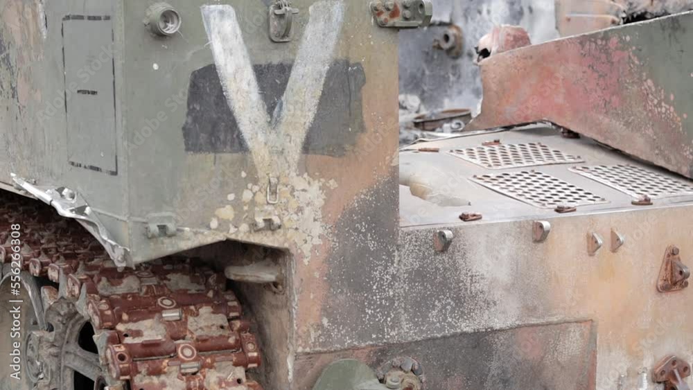 Destroyed, wrecked and burned T-72 tank with a designation V on it ...