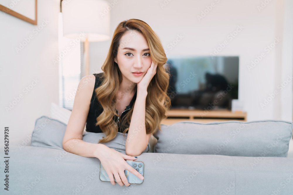 beautiful woman touching cheek holding phone. relax beautiful gorgeous ...