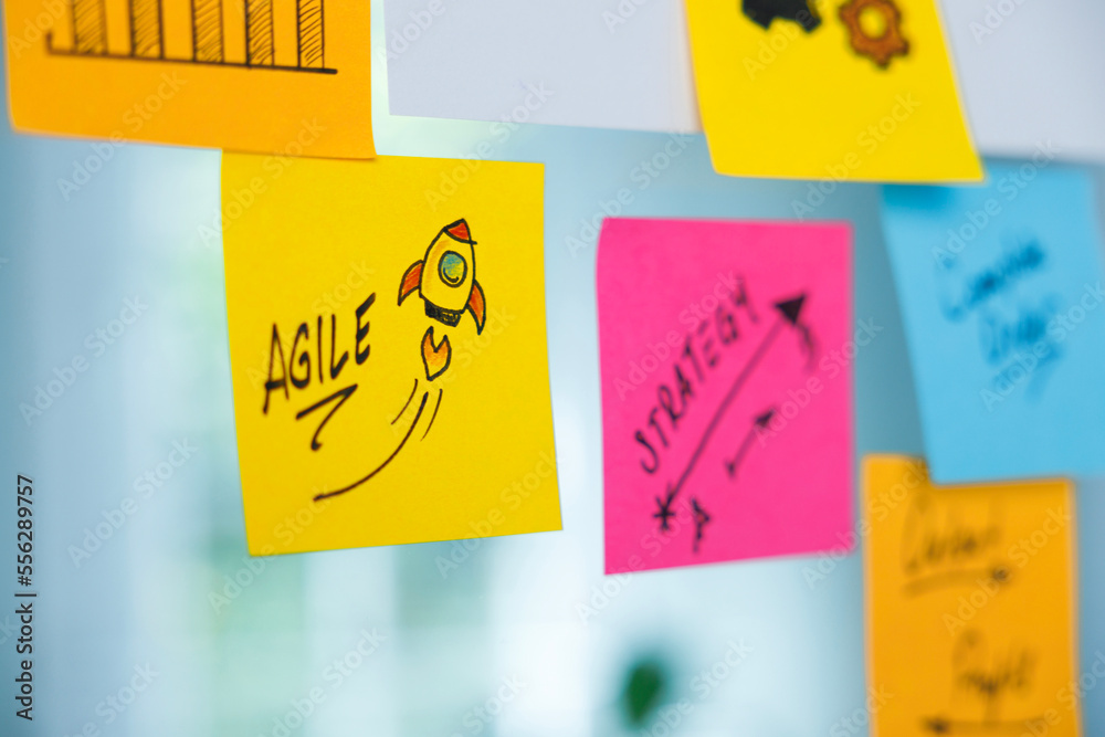 The word Agile and rocket symbol on a yellow adhesive note. Stock Photo ...
