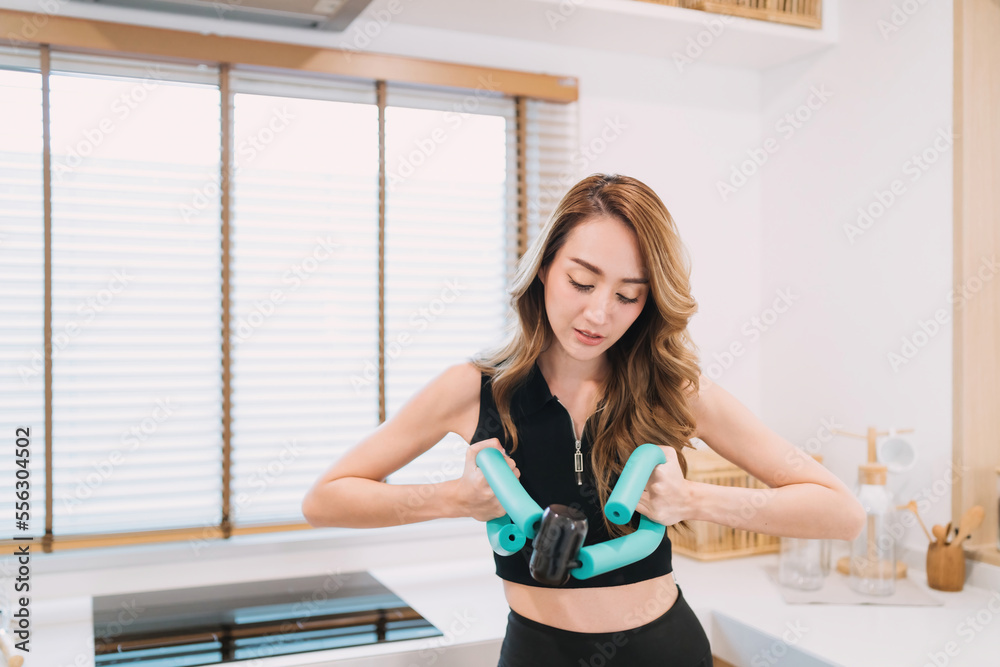 gorgeous woman using fitness device exercising in kitchen. beautiful ...