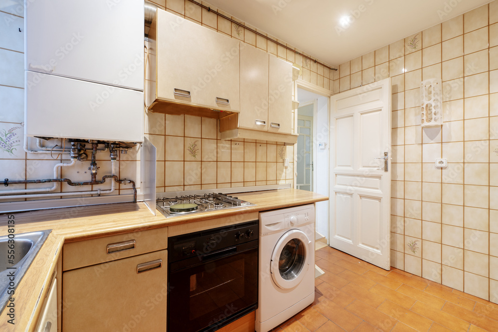 Corner of a kitchen with wooden furniture with an old wooden worktop ...