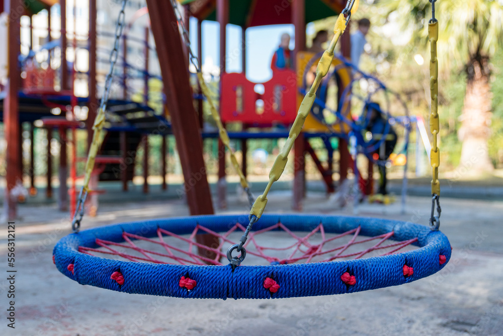Large mesh swing in the playground. Round swing seat made of mesh in ...
