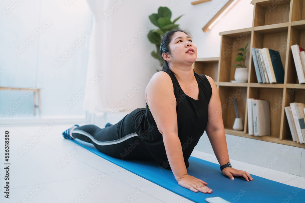 chubby woman doing yoga position indoors. fat female spiritual person ...