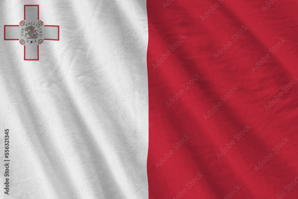 Malta flag with big folds waving close up under the studio light ...