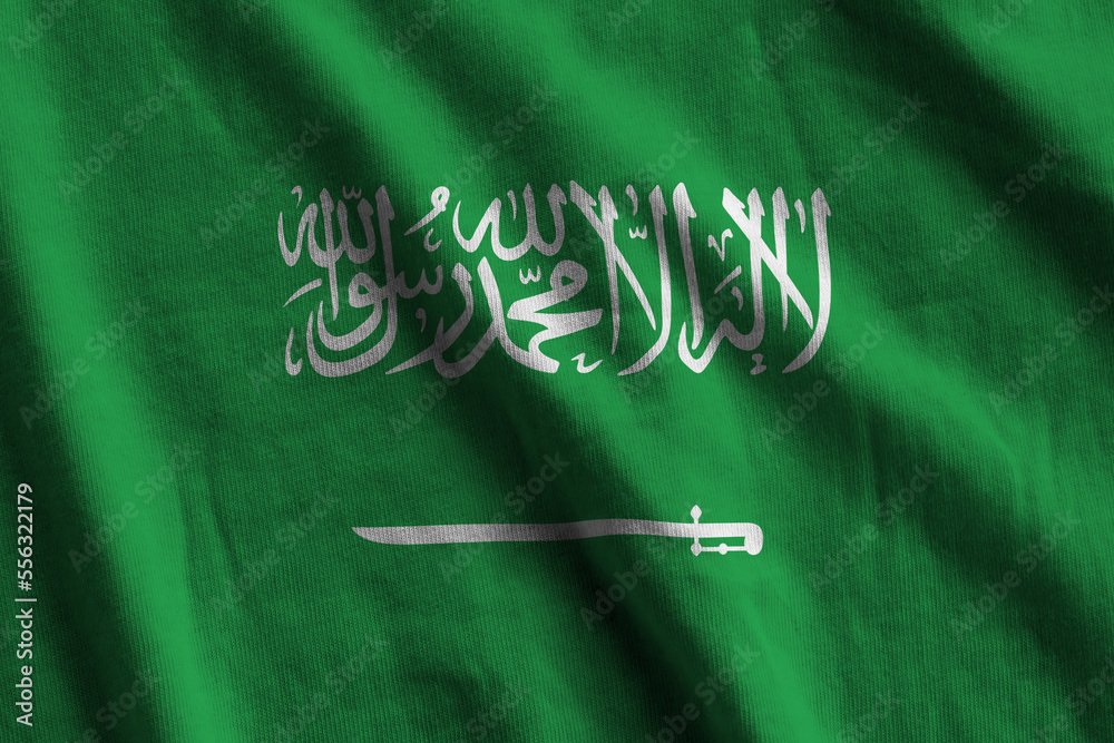 Saudi Arabia flag with big folds waving close up under the studio light ...