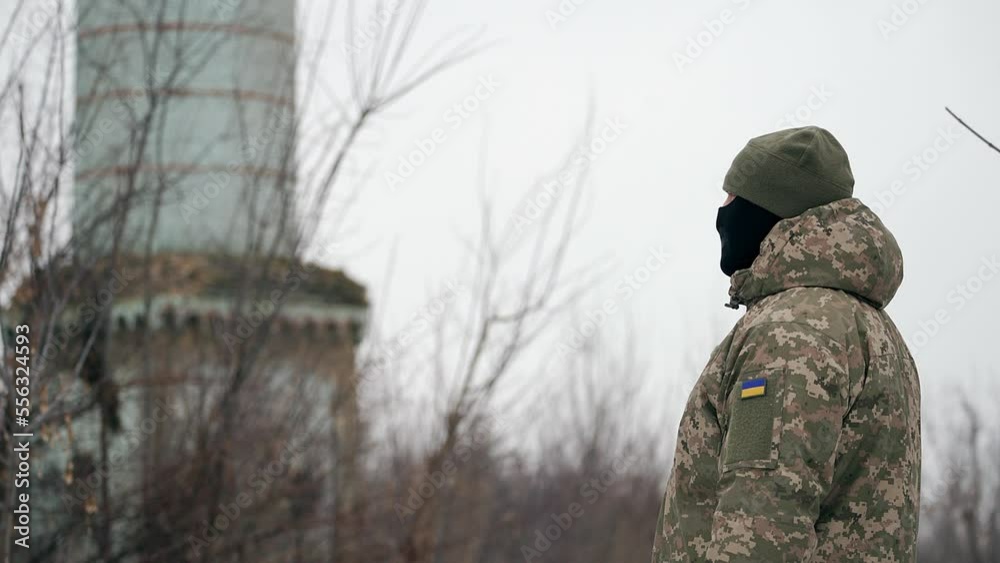Soldier of the Armed Forces of Ukraine in a winter uniform walks on the ...