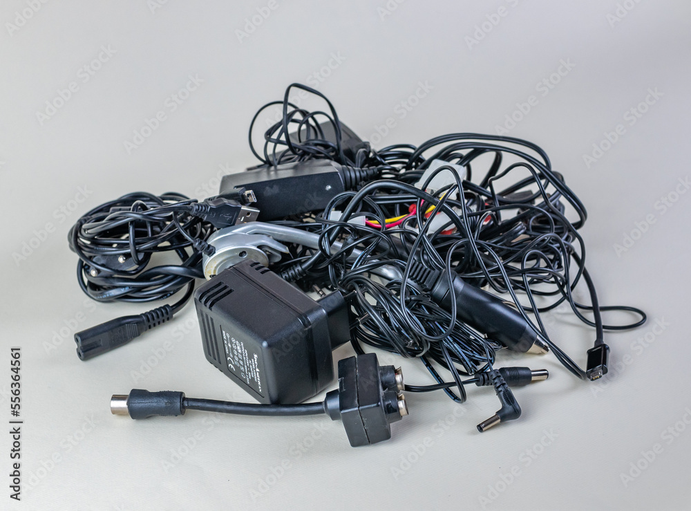 Bunch of old wires, connections and chargers for modern devices close ...