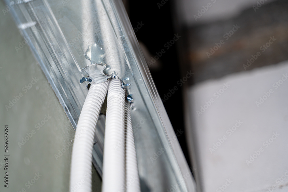 The wires in the protective corrugated pipe are led through the hole ...