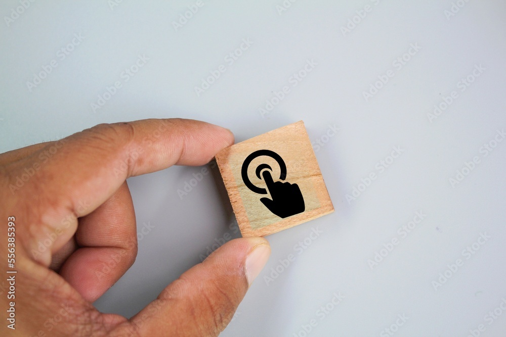 hand holding wooden square with fingerprint or touch screen icon ...