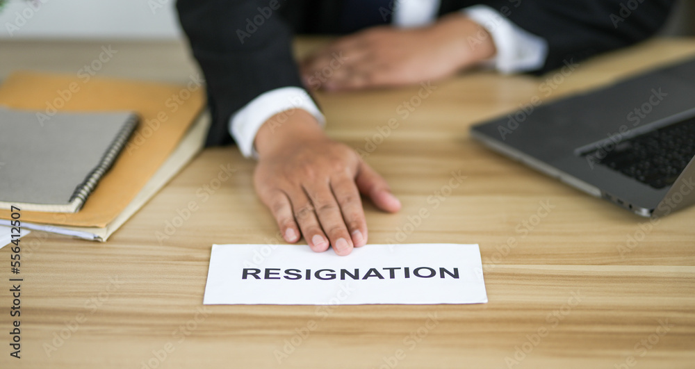 Resignation letter and cardboard box on the table, termination and ...