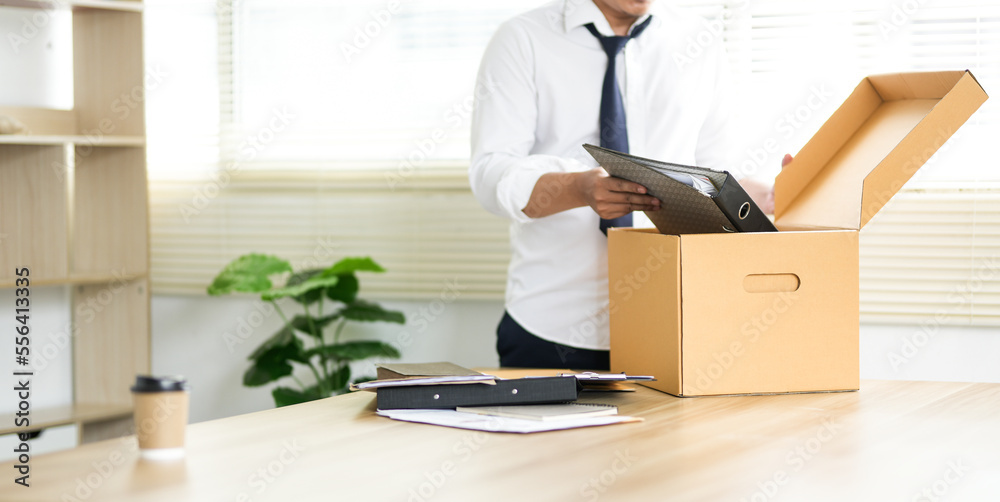 Resignation letter and cardboard box on the table, termination and ...