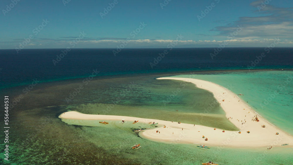 Tropical white island and sandy beach with tourists surrounded by coral ...