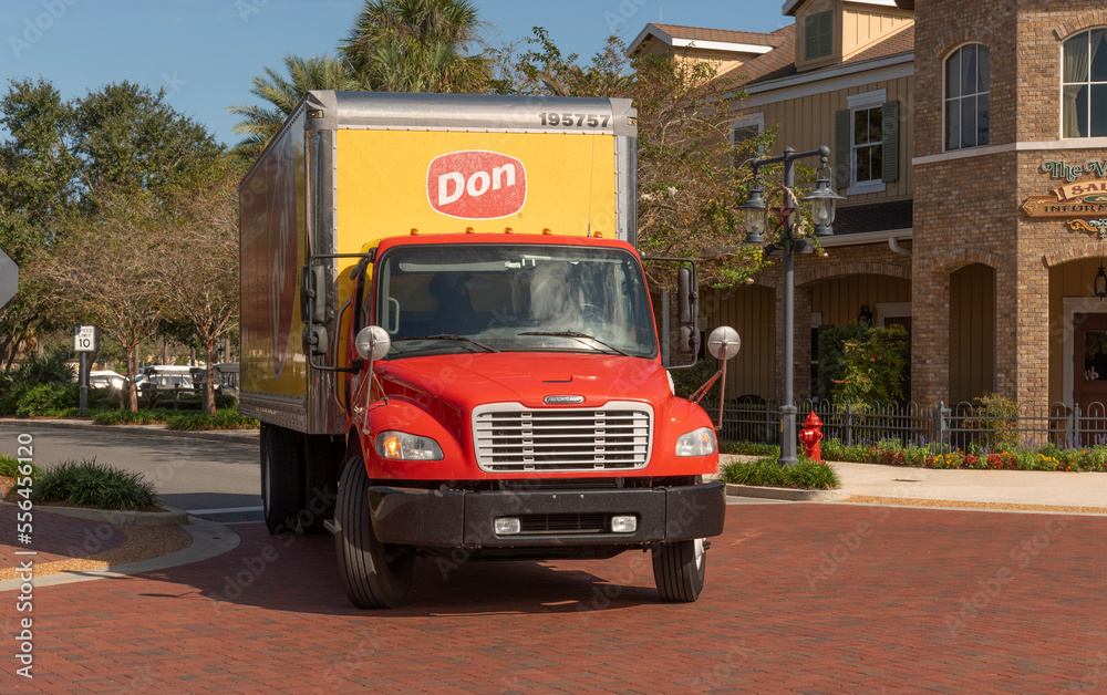 The Villages, Florida, USA. 2022. Red and yellow coloured delivery ...