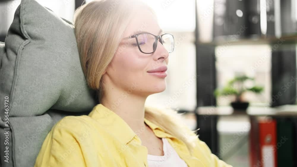 Relaxed calm businesswoman with closing eyes laying on chair after hard ...