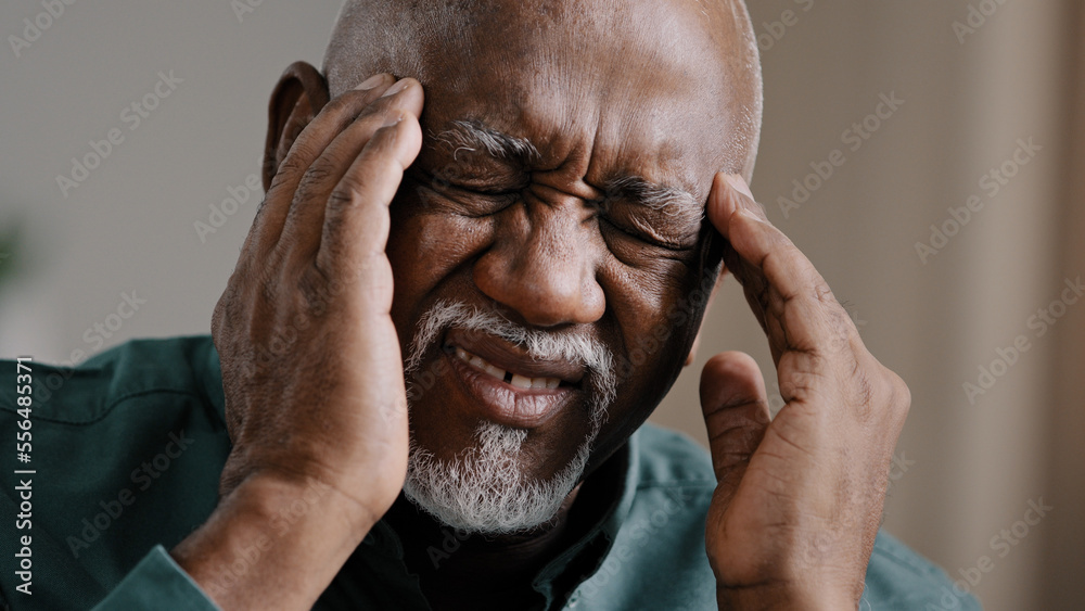 Close-up face sad elderly african american man feeling headache chronic ...
