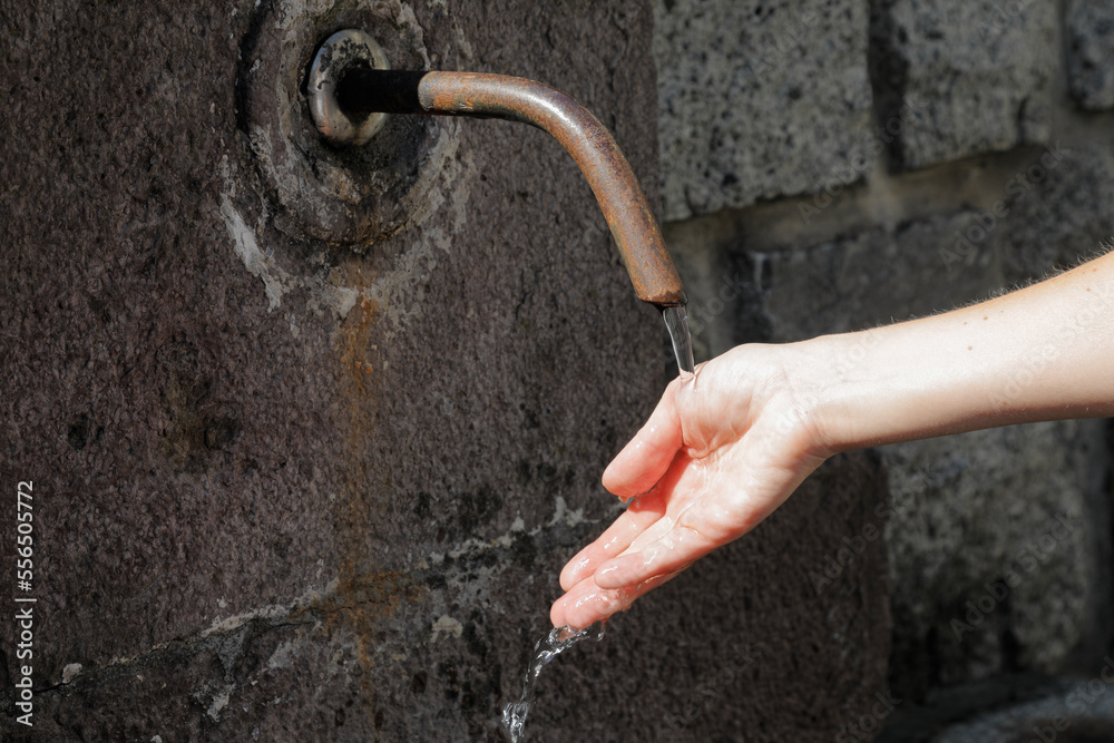 Water fountain with a hand, water splashing on hands, horizontal, one ...