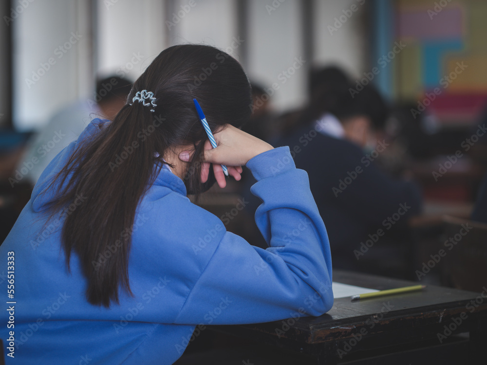 Students reading exam answer sheets exercises in classroom of school ...