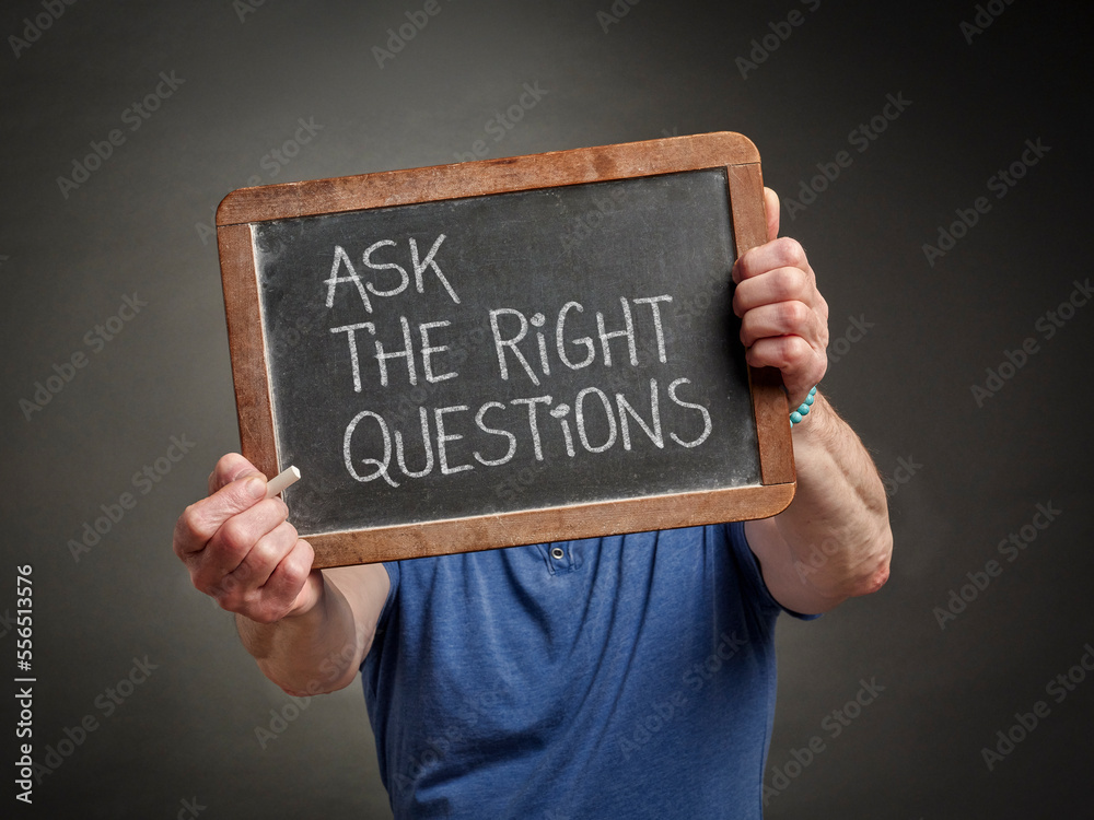 ask the right questions - white chalk text on a slate blackboard held ...
