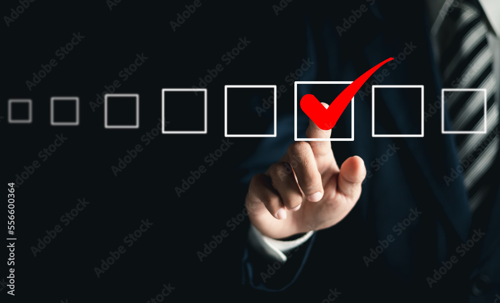 Businessman touching square box with correct icon on virtual interface ...