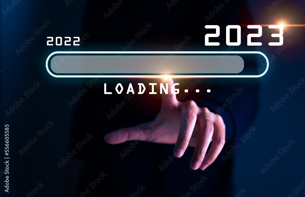 Businessman hand touching and pointing on loading bar year 2023 with ...