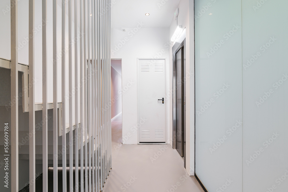 Corridor with passenger lift and stairs leading up. Interior of modern ...