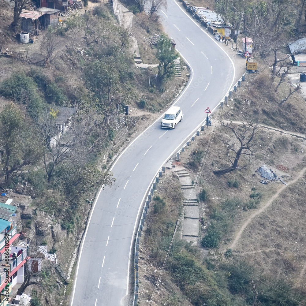 Aerial top view of traffic vehicles driving at mountains roads at ...