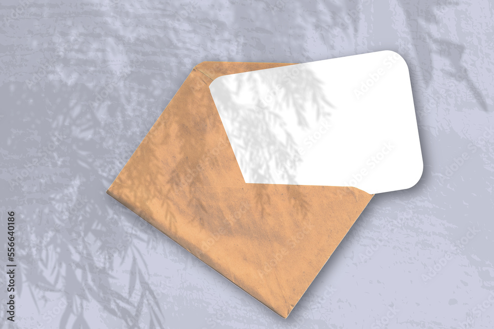 An envelope with sheet of textured white paper on the blue background ...