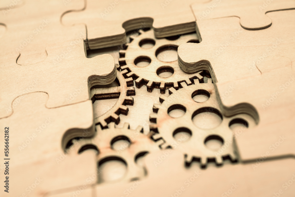 solving the problem concept - puzzles and cogwheels. wooden gears under ...