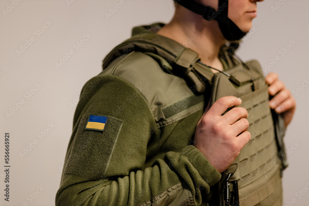 Armed Forces of Ukraine. Ukrainian soldier stands and holds hands on ...