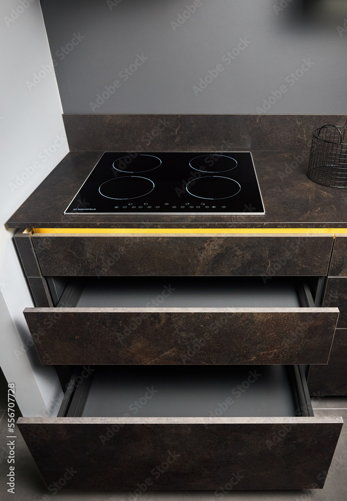 Induction cooker black glass hob or aspirating induction hob on marble ...