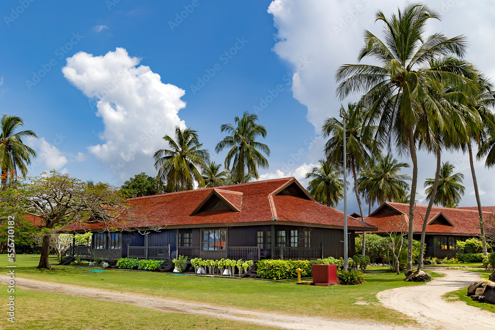 Malaysia, Langkawi, November, 2022: Two-storey wooden bungalows among a ...