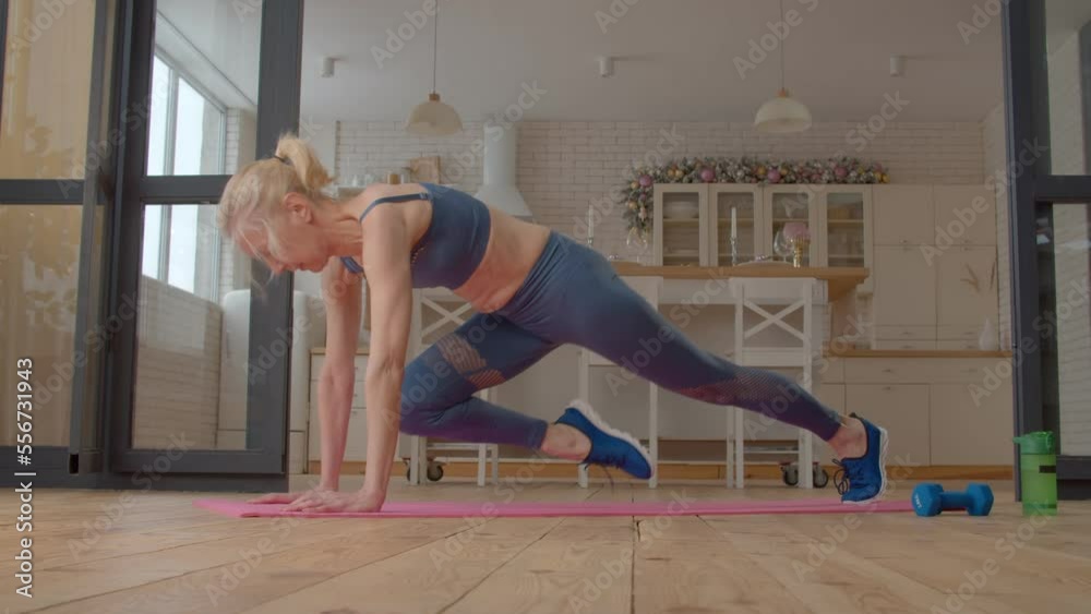 Determined active charming sporty fit mature female stretching in ...