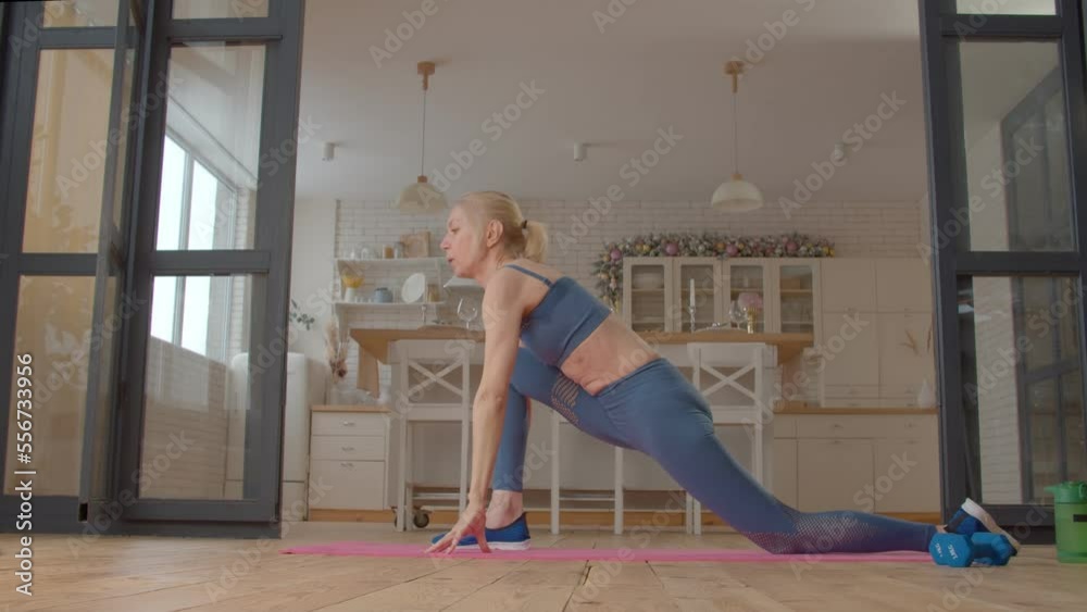 Charming active motivated sporty fitness senior female working out yoga ...