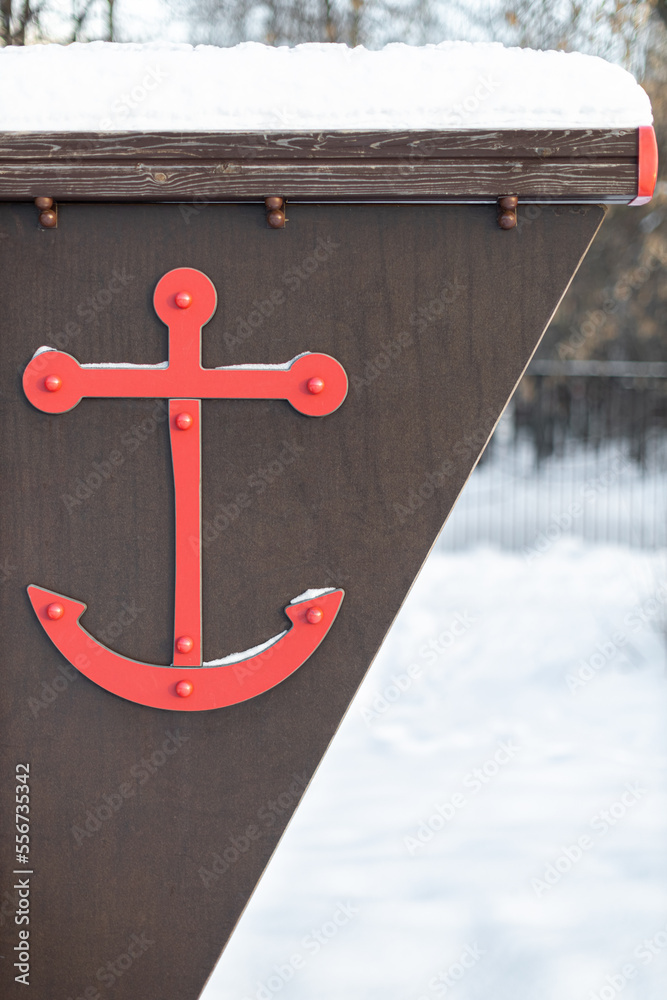 decorative anchor of red color on the wall on the street Stock Photo ...
