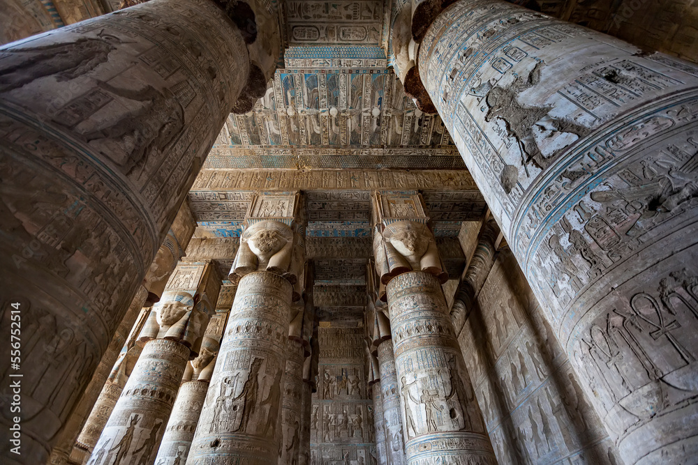 Stone columns and ceiling displaying hieroglyphic carvings at the ...