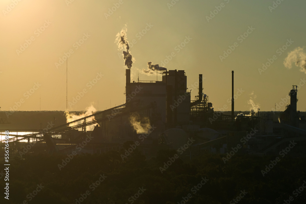 Huge factory with high chimneys polluting atmosphere with carbon ...