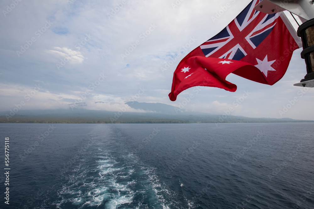 Red Australian Ensign flag flying from the stern of an expedition boat ...