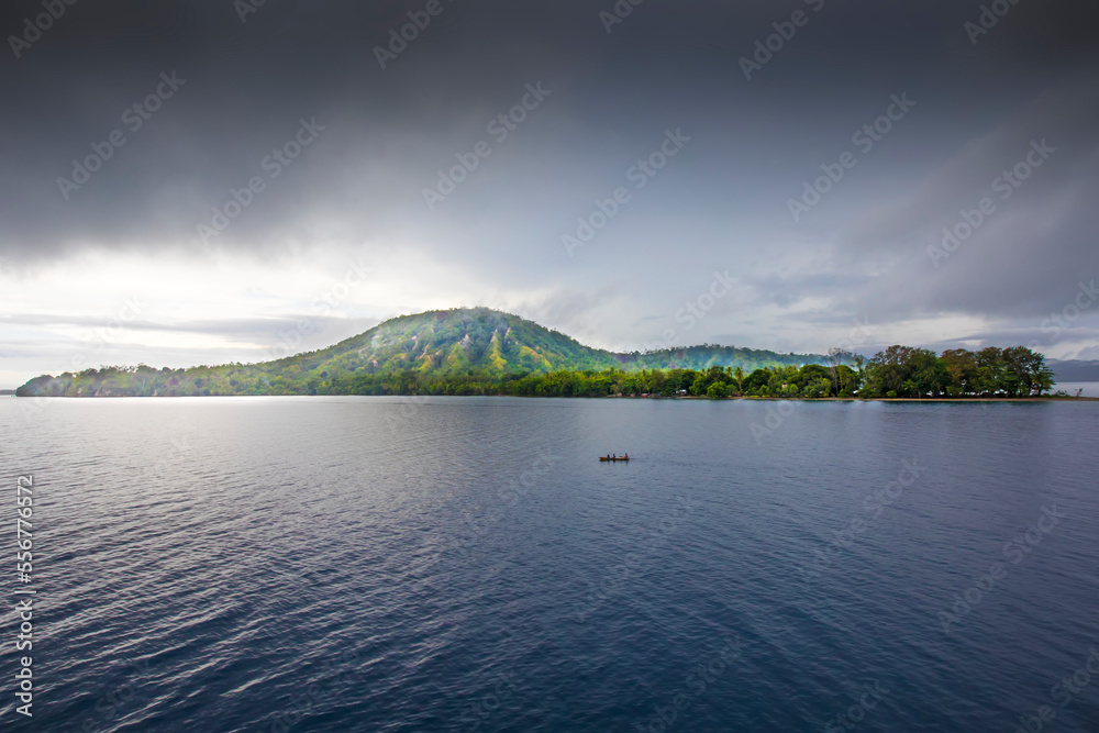 People in a canoe in front of the jungles of Dobu Island, D ...