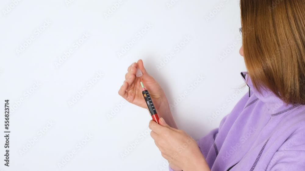 Women or girl thread a disposable needle onto a insulin pen or syringe ...