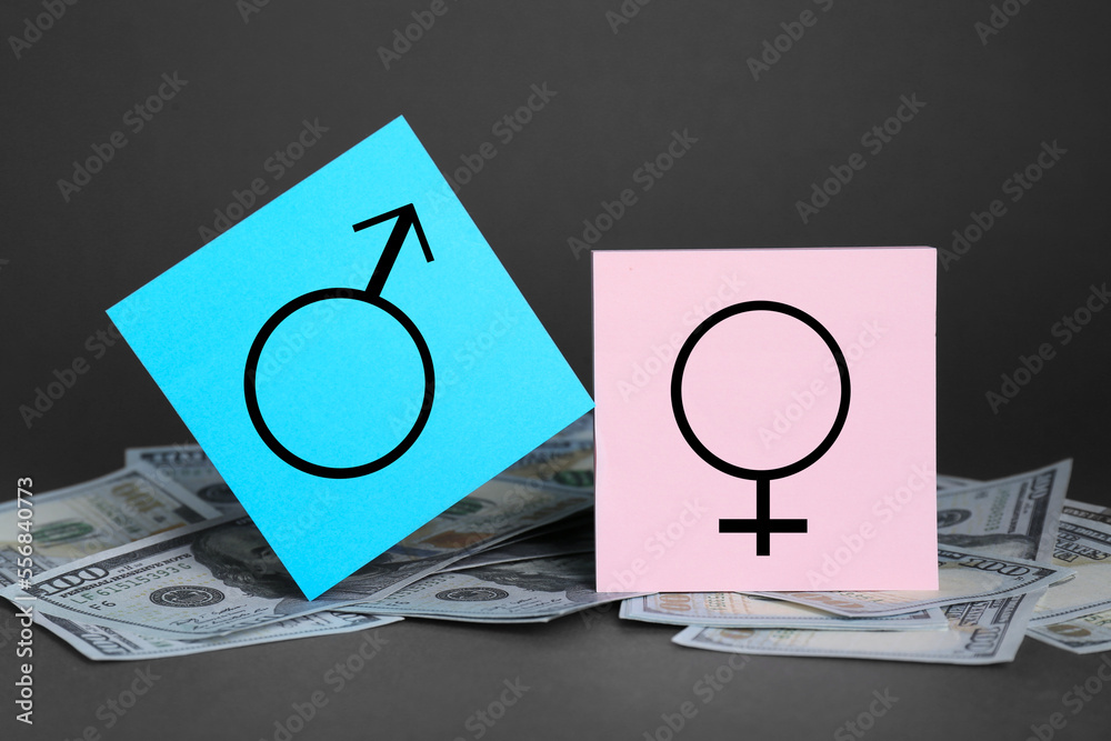 Gender pay gap. Male and female symbols on dollar banknotes against ...
