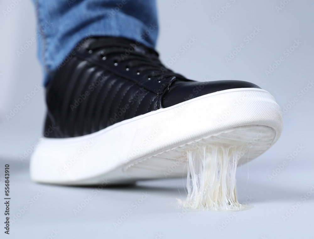 Man stepping into chewing gum on light grey background, closeup Stock ...