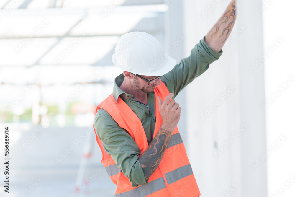 Supervisor male engineer wearing a protective vest and safety hard hat ...
