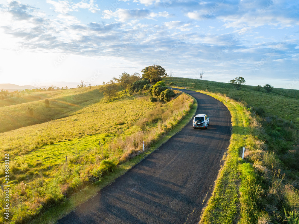 4x4 car driving on country road trip adventure on narrow road at sunset ...