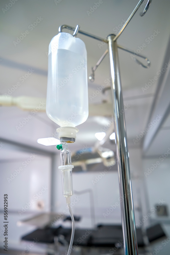 Intravenous or Iv fluids drip bottle hanging on a metal pole in ...